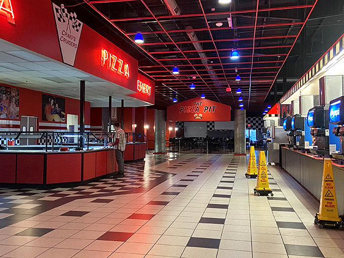 The food court's checkered floors mirror the racing theme, while hungry adventurers refuel between go-kart victories and arcade conquests.