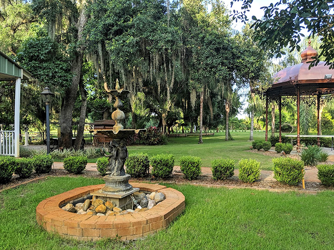 Tranquility flows freely at the ornate fountain, where water dances and splashes beneath Spanish moss-draped oaks in a symphony of serenity.