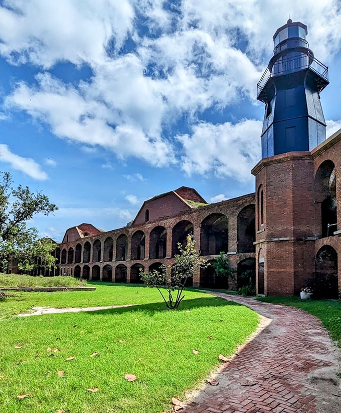 The lighthouse stands sentinel, guiding visitors to this remote outpost where history meets tropical splendor.