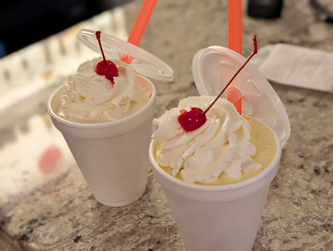 Simple pleasures done right &ndash; vanilla milkshakes topped with whipped cream and cherries. Sometimes happiness comes with a straw.