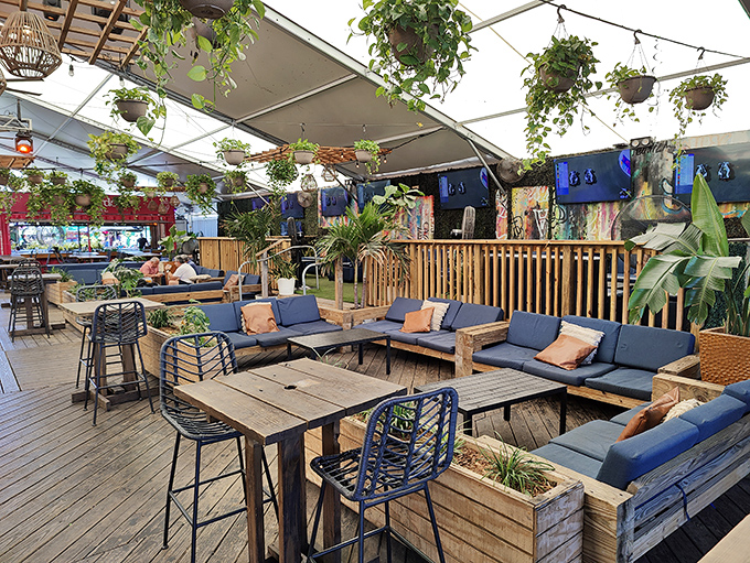 The Deck's outdoor seating area blends tropical vibes with urban cool &ndash; those hanging plants aren't just decoration, they're conversation starters!