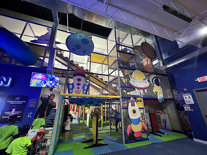 Little astronauts navigate this multi-level play structure, where cosmic-themed adventures unfold beneath twinkling stars and planetary decorations.