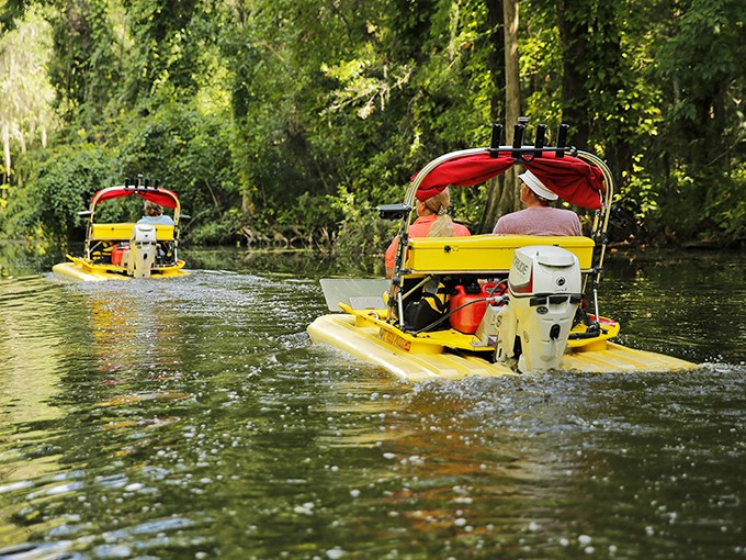 Bright yellow tour boats navigate the narrow passages, offering a comfortable way to experience this natural wonder without getting your feet wet.