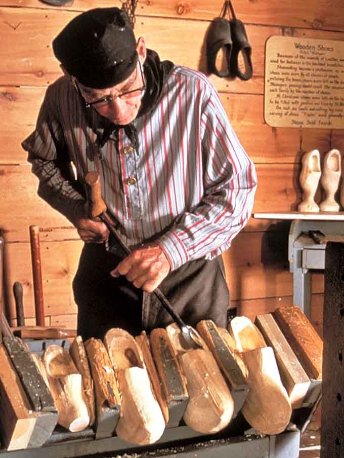 Craftsmanship in motion: A master woodworker shapes wooden shoes using techniques passed down through generations, turning lumber into legendary footwear.