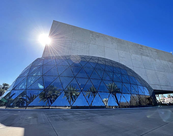 The modern building sparkles against the bright Florida sky like a giant jewel box full of strange treasures.