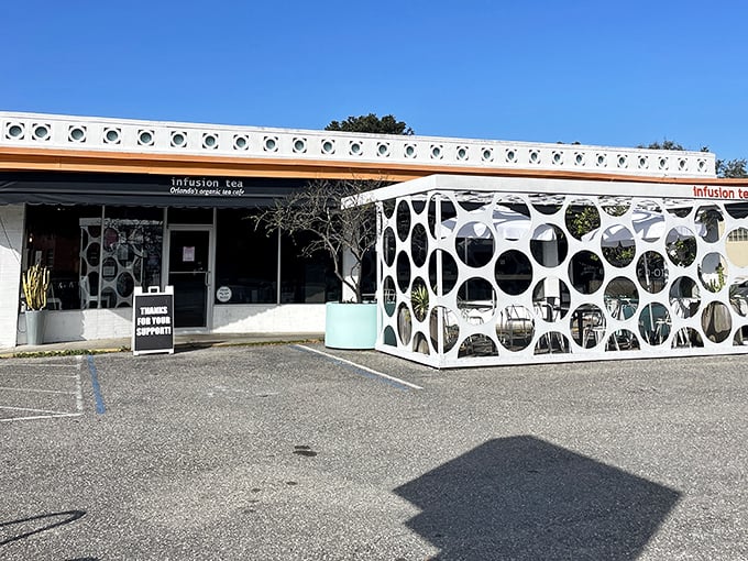 The modern tea house features distinctive bubble-shaped cutouts that create an artistic, light-filled patio space.