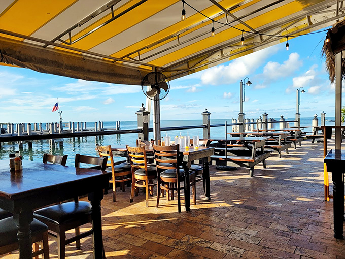 The open-air dining area at Island Fish Company puts you right at the water's edge, where boats bob gently as you tackle a mountain of conch fritters.