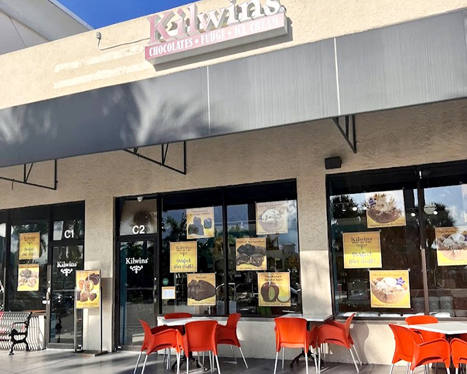 Bright orange chairs invite customers to linger outside Kilwins, turning ice cream into a social event.