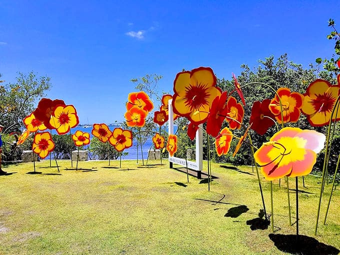 Giant metal blooms tower against blue skies, proving that art and nature make wonderful companions in the garden.
