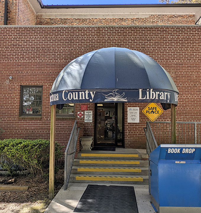 The Alachua County Library's Micanopy branch serves as both literary haven and community hub, its blue awning a beacon for bookworms.