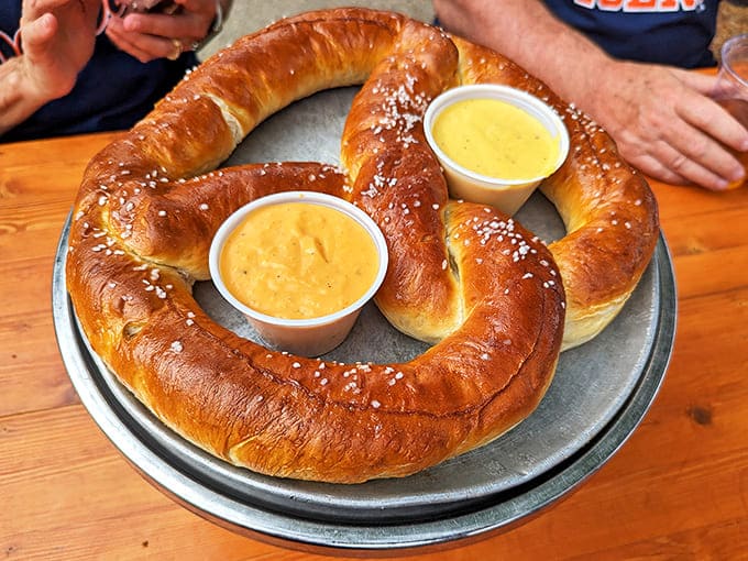 This isn't just any pretzel &ndash; it's a golden-brown masterpiece that arrives looking like it's flexing, accompanied by beer cheese and sweet mustard.