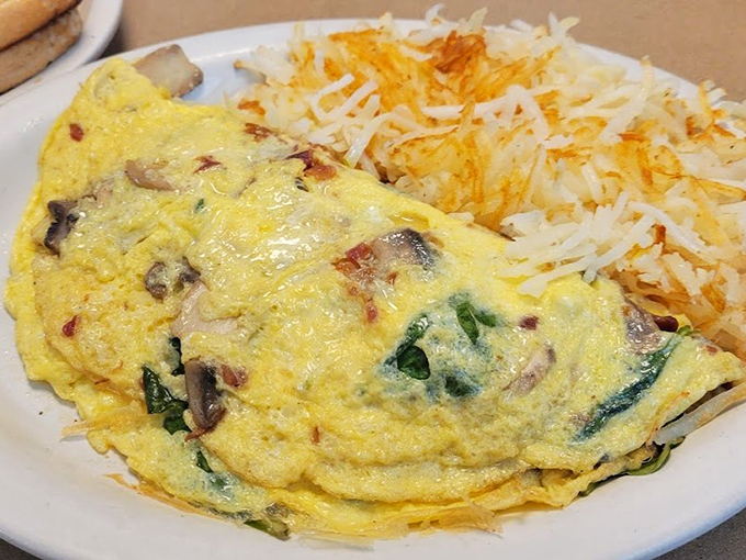 This baked omelet arrives like a rockstar &ndash; fluffy, golden, and packed with fresh ingredients that harmonize perfectly with those crispy hash browns.