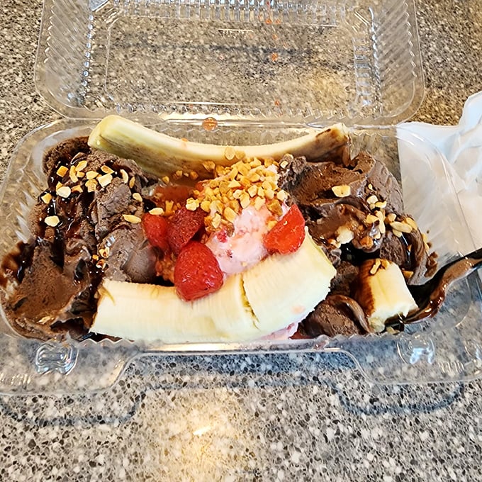 Behold the banana split in all its glory: three scoops, two banana halves, and enough toppings to make nutritionists weep into their kale.