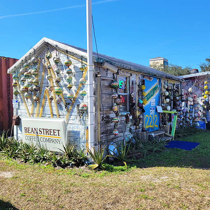 Bean Street Coffee Company's weathered sign hints at caffeinated pleasures amid the artistic chaos, a quiet corner in the creative storm.