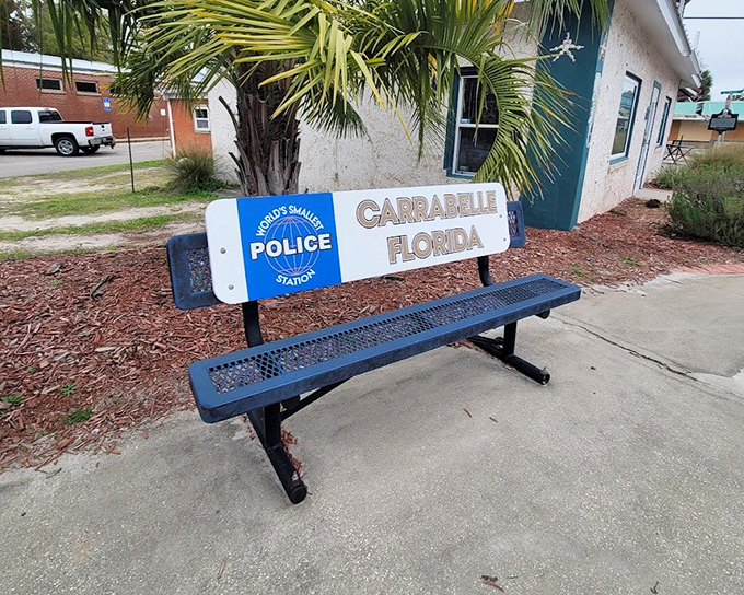 "World's Smallest Police Station" proudly emblazoned on a bench that's actually larger than the station itself&mdash;talk about irony!