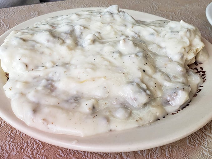 This isn't just biscuits and gravy—it's a cloud-like pillow of dough swimming in a sea of peppery, sausage-studded heaven.
