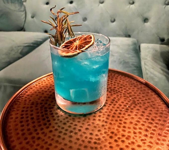 This electric blue cocktail isn't just Instagram bait &ndash; it's a refreshing chapter in your evening's story, garnished with dried citrus and herbs.