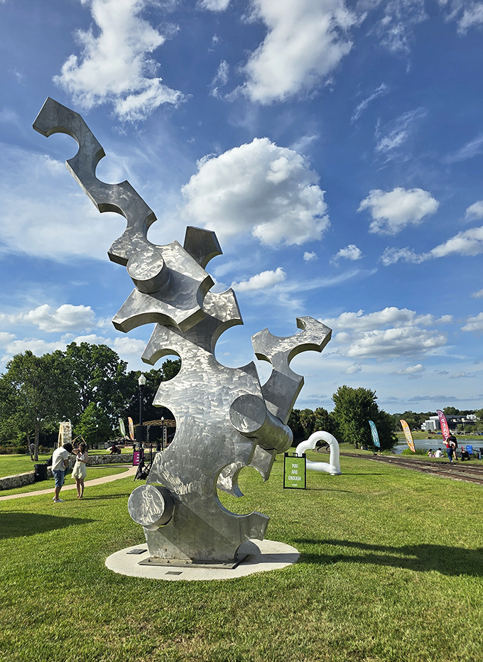 "Cause & Effect" reaches skyward with geometric precision, a metallic puzzle that changes personality as sunlight shifts throughout the day.