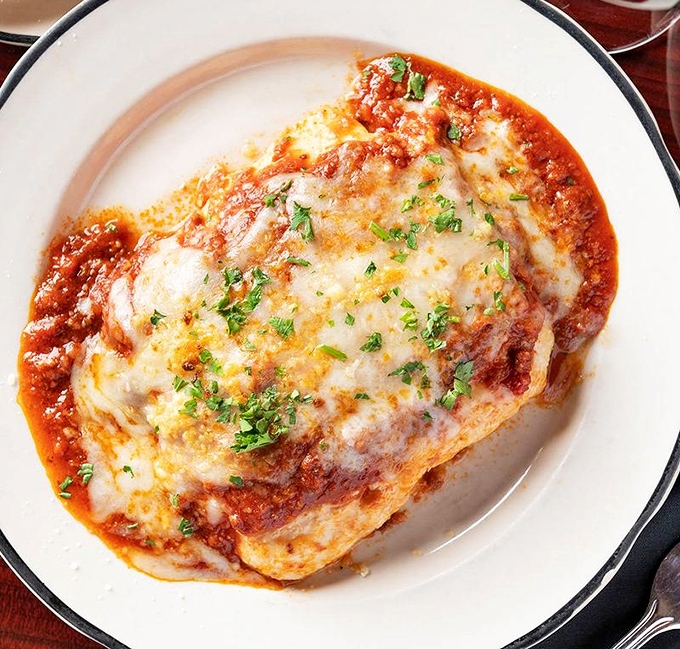 Chicken Parmigiana: Crispy, saucy, cheesy perfection &ndash; this isn't just chicken parm, it's a hug on a plate that makes Monday feel like Saturday.