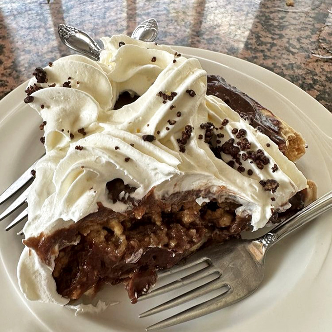 A slice of the legendary Chocolate Peanut Butter Pie that's worth the drive alone &ndash; layers of decadence topped with a cloud of whipped cream.