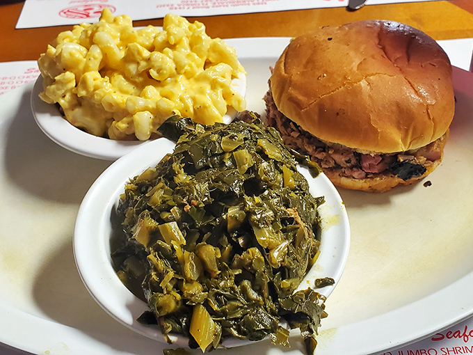 The legendary chopped pork sandwich with creamy mac and cheese and collards &ndash; a holy trinity of Southern comfort on a single plate.