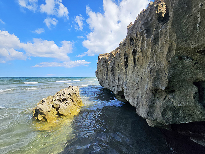 Imposing limestone cliffs stand sentinel against the relentless sea, a rare geological treasure on Florida's typically sandy shores.