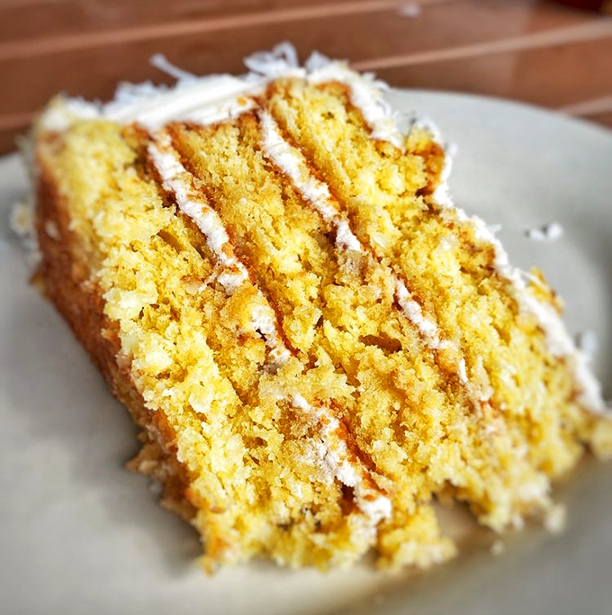 Behold the star attraction &ndash; layers of moist yellow cake embraced by creamy frosting and crowned with sweet coconut flakes.