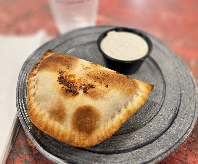 Golden-brown perfection gives way to savory filling in this hand-held treasure, accompanied by a creamy dipping sauce that elevates each bite to new heights.