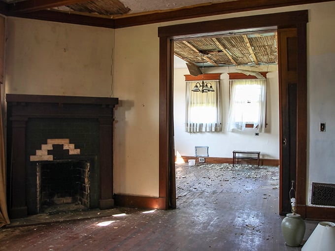 The fireplace stands cold but dignified, its green tile surround a whisper of evenings spent in warm conversation.