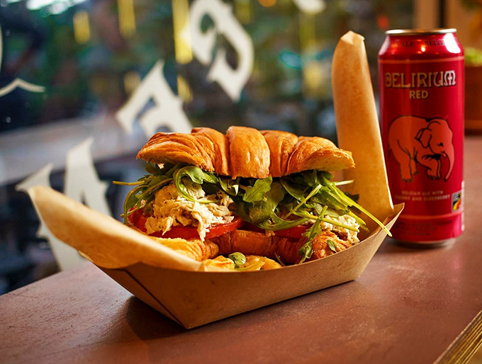 This isn't just lunch, it's edible architecture – layers of goodness nestled in a perfectly toasted croissant alongside house-made chips.