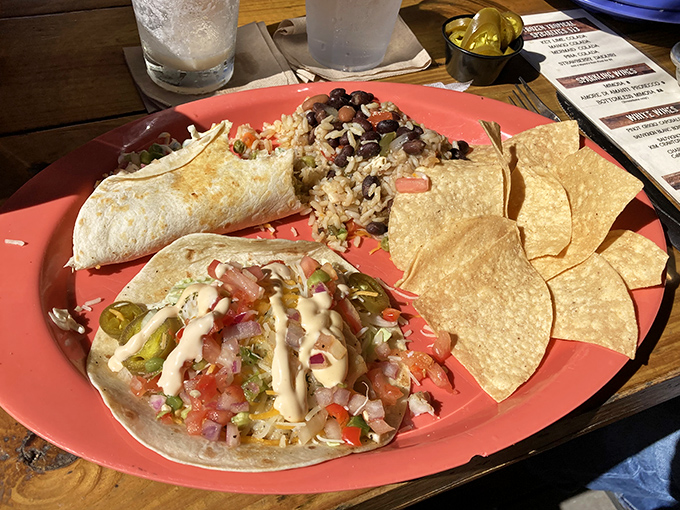 Taco perfection: Fresh fish nestled in soft tortillas with colorful toppings, served with black beans and rice &ndash; vacation on a plate.