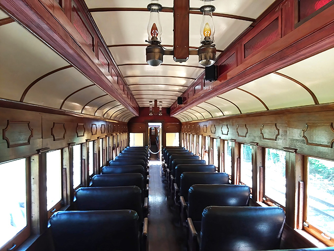Step inside a vintage passenger car where oil lamps cast a warm glow and wooden seats tell stories of travelers from another era.