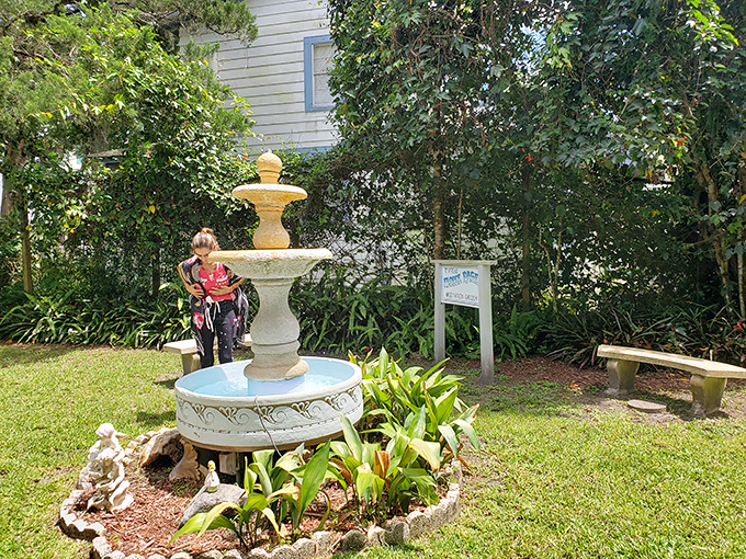 A serene fountain creates a peaceful oasis in the meditation garden, where visitors contemplate life's mysteries or simply escape Florida's relentless humidity.