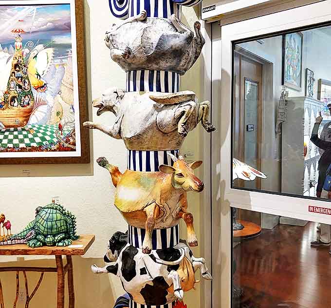The barnyard Jenga tower defies both gravity and conventional museum etiquette. These farm animals look simultaneously alarmed and resigned to their artistic fate.