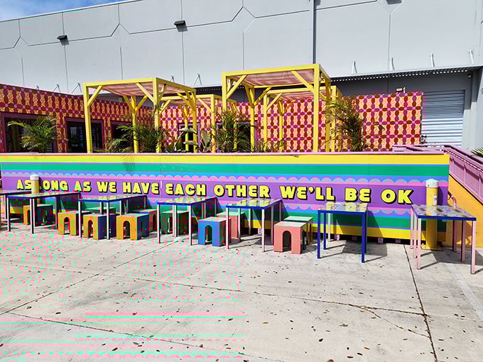 The outdoor courtyard serves up a rainbow buffet of colors and shapes, proving that even the rest areas at Superblue refuse to be boring.