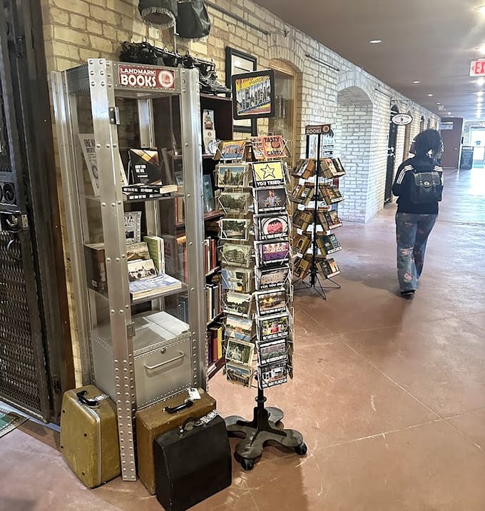 Vintage suitcases anchor displays of local literature and postcards – perfect souvenirs for those who appreciate the irony of sending "Wish you were here" from a former asylum.