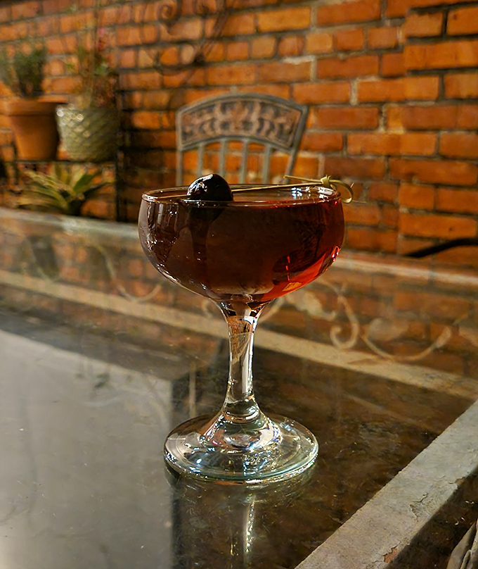 Red Wine: Ruby elixir catches the light against weathered brick &ndash; this isn't just wine, it's a burgundy jewel in a vintage setting.