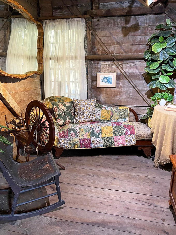 Rustic charm meets historical authenticity in this cozy corner, where a patchwork quilt and spinning wheel transport visitors to simpler times.