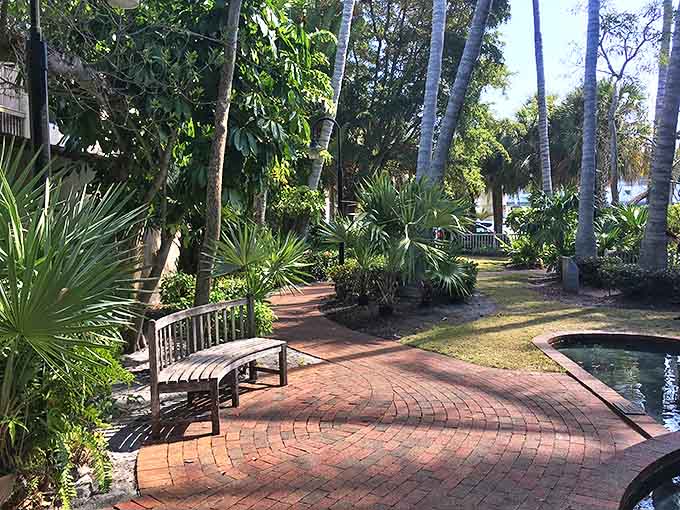 A tranquil brick pathway winds through Sam Murphy Park, where benches invite visitors to pause and breathe.