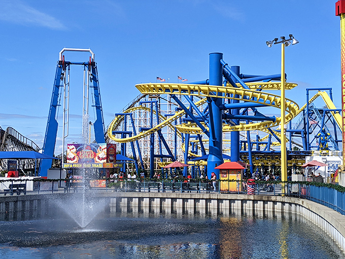 The park's colorful attractions create a kaleidoscope against the Florida sky, each ride competing for attention like performers at a carnival.