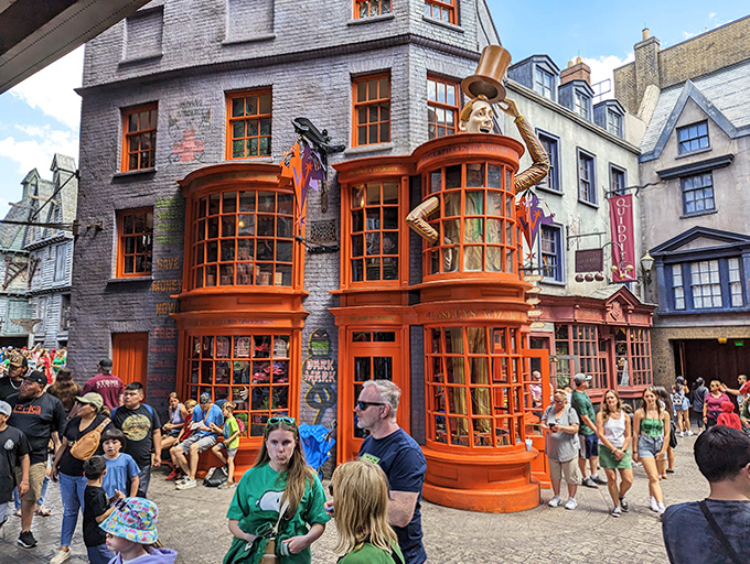 Weasleys' Wizard Wheezes shop stands proudly in Diagon Alley, its vibrant orange fa&ccedil;ade and mischievous details bringing magical pranks to muggle visitors.