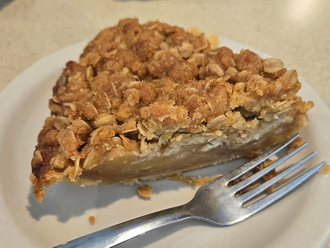 This isn't just apple crumb pie &ndash; it's edible architecture with a buttery, cinnamon-kissed topping that crumbles with delightful abandon.