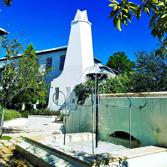 A playful fountain creates liquid music against stark white walls, offering a refreshing counterpoint to Alys Beach's architectural precision.