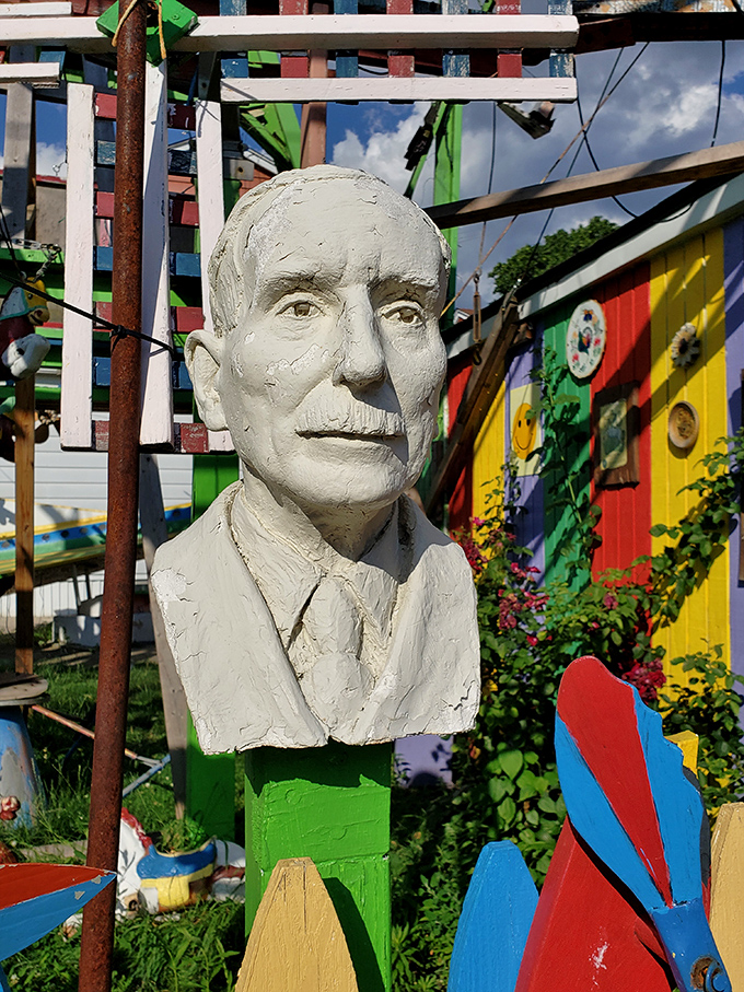 This stoic bust stands as a dignified sentinel amidst the creative chaos, like a professor who wandered into a carnival by mistake.