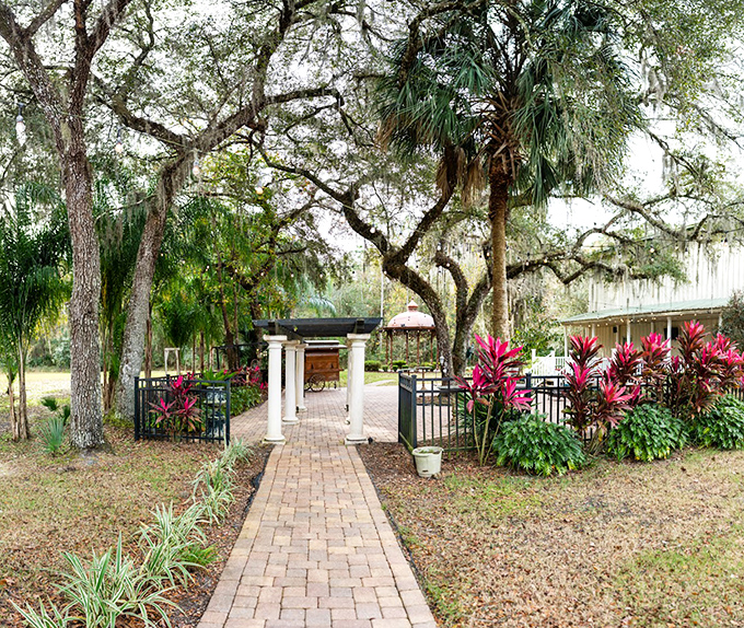 Brick pathways meander through lush gardens, inviting wanderers to discover hidden corners of this enchanted property one step at a time.