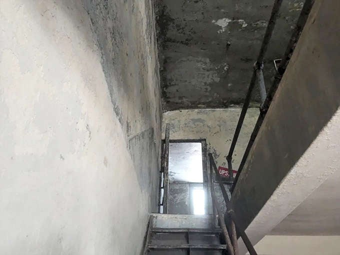 Climbing these stairs is like ascending into the past, except the past has questionable structural integrity and no handrail warranty.