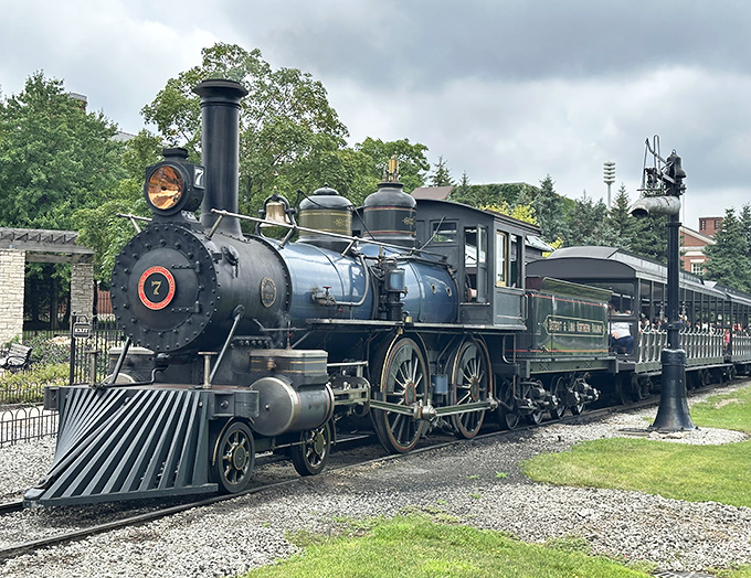 Steam locomotive No. 7 gleams in the Michigan sunshine, its polished brass and steel telling stories of transcontinental dreams and engineering triumph.