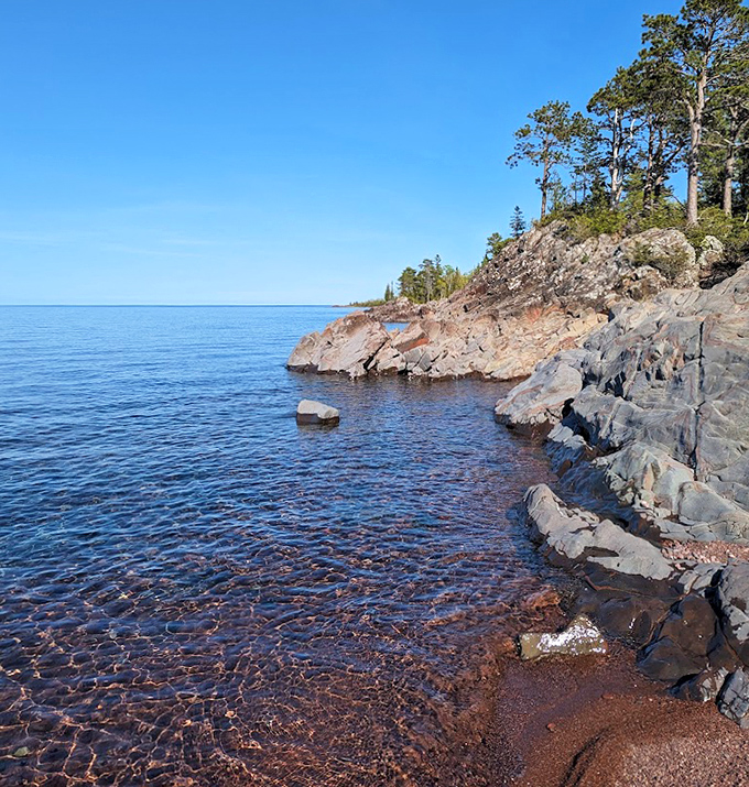 Lake Superior's rocky shoreline tells ancient stories in stone, where the Great Lake meets land in a dramatic geological handshake.