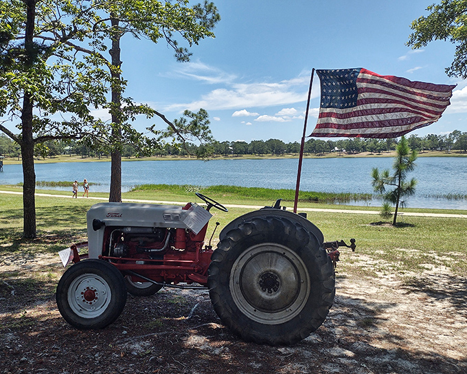 This vintage tractor, proudly displaying Old Glory, stands sentinel by the shoreline – a charming reminder of DeFuniak Springs' agricultural roots and patriotic spirit.