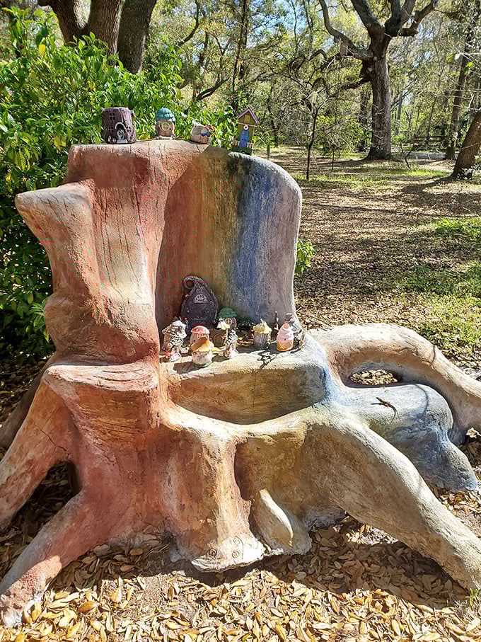 Nature becomes art in this rainbow-hued tree stump throne, where miniature mythical residents hold court among the fallen leaves.
